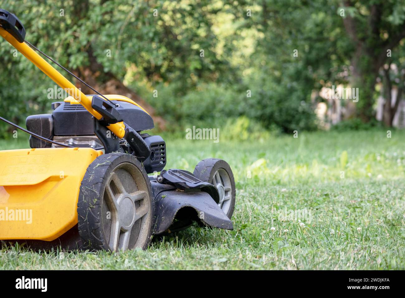 Lawnmower on cut grass Stock Photo - Alamy