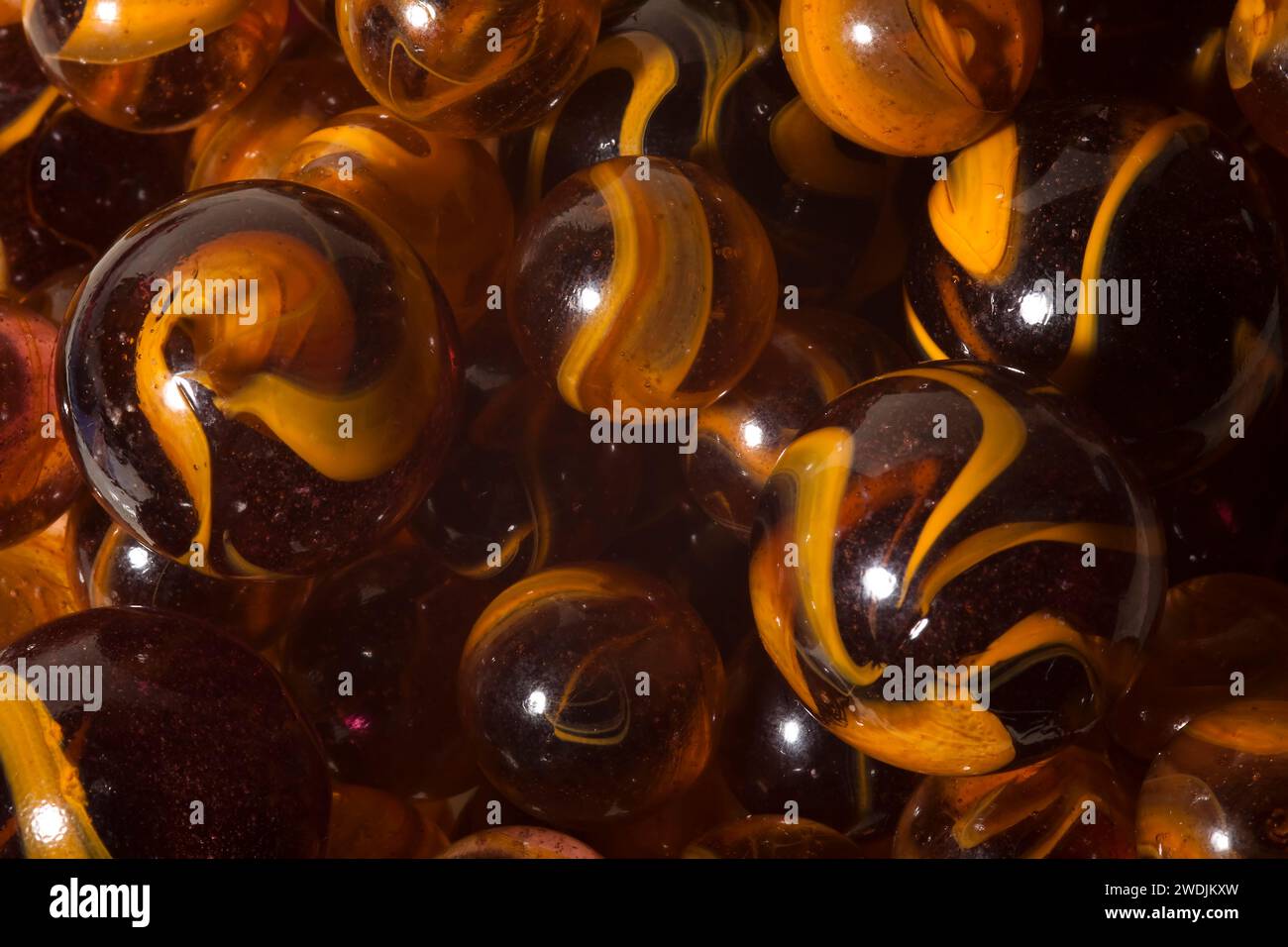 Brown and orange swirl glass marbles Stock Photo - Alamy