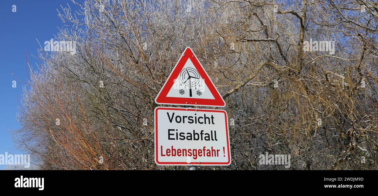 a sign on a wind turbine with the text "caution icefall, danger to life ...