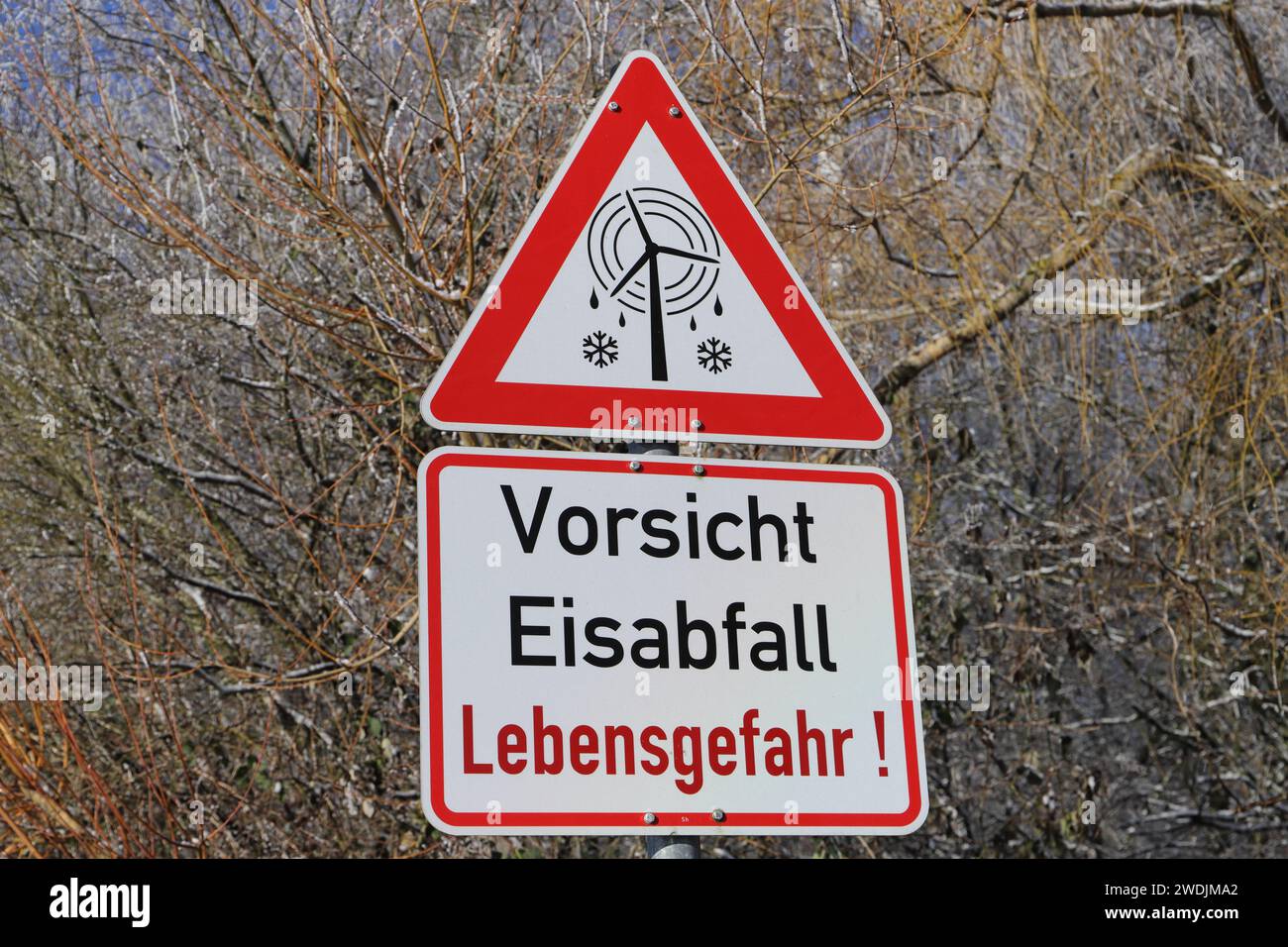 a sign on a wind turbine with the text "caution icefall, danger to life ...