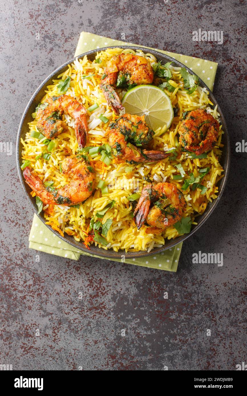 Meygoo Polo pilaf Rice with herbs and prawns closeup on the plate on ...