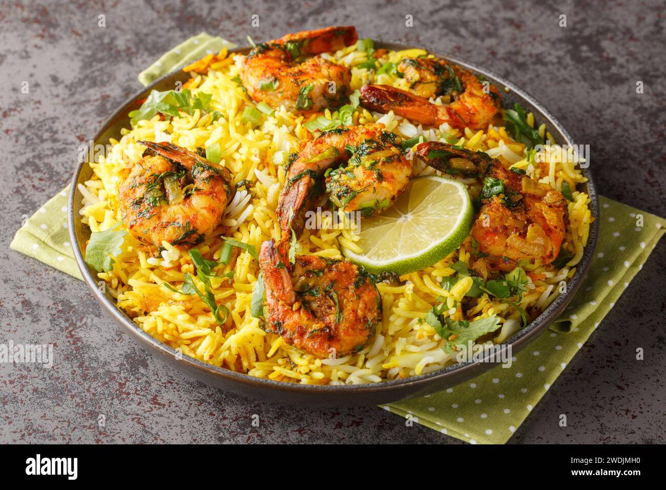 Popular Iranian seafood pilaf Meygoo Polo with herbs and prawns closeup ...