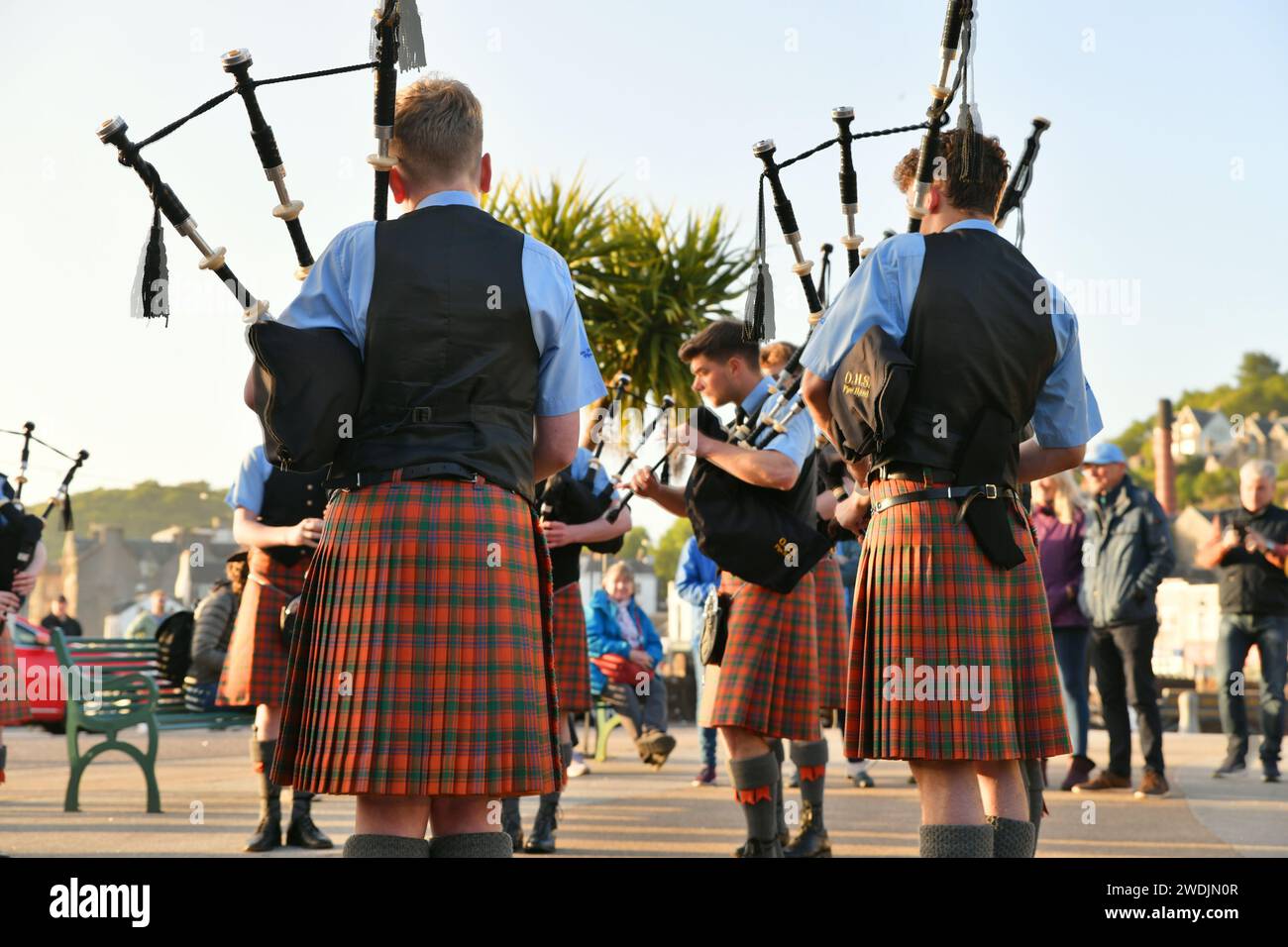 Members of the Oban High School Pipe Band playing in the town centre of ...