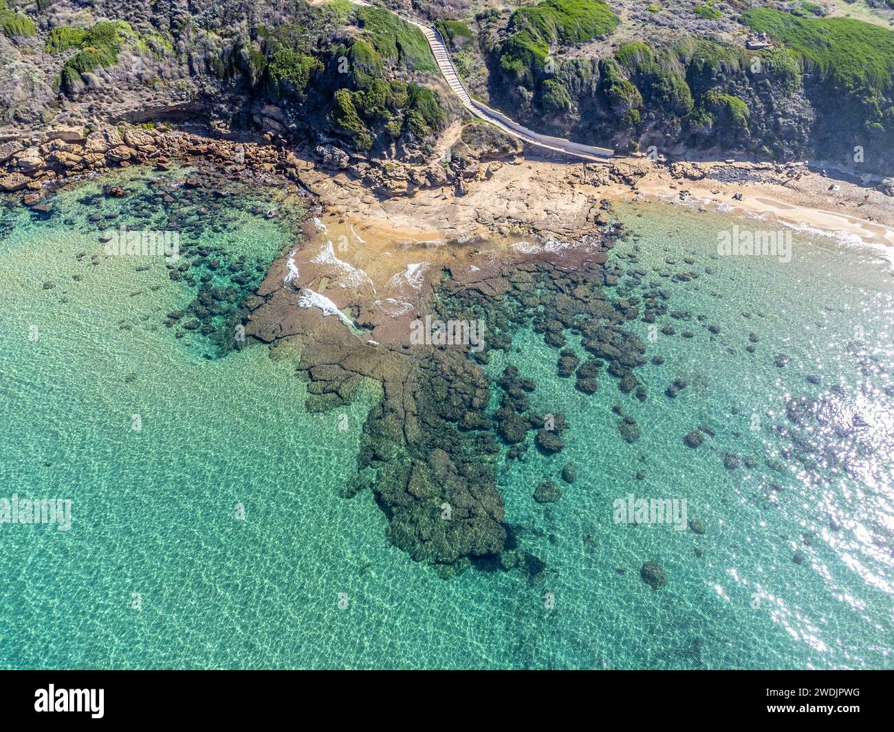 Aerial view of clear water and rocks in Lu Bagnu shoreline. Sardinia ...