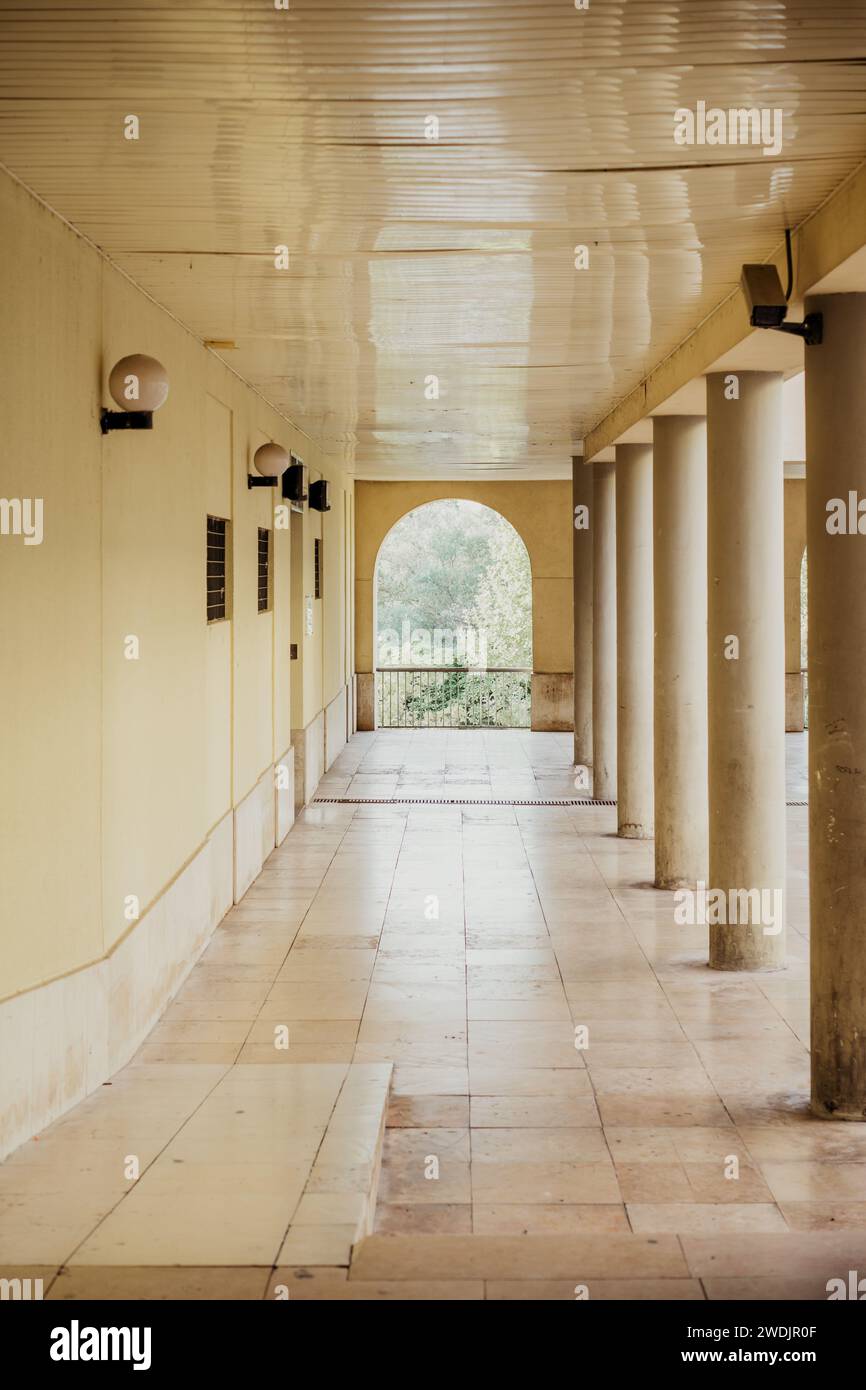 A vertical of a hallway with arched columns Stock Photo - Alamy