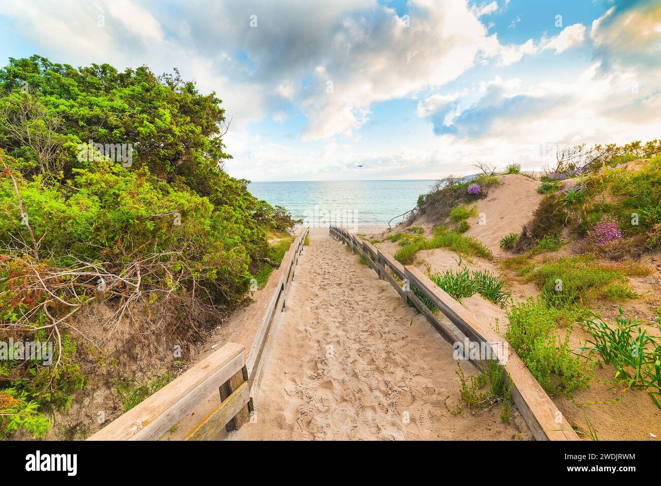 Walkpath to the beach in Alghero at sunset. Sardinia, Italy Stock Photo - Alamy
