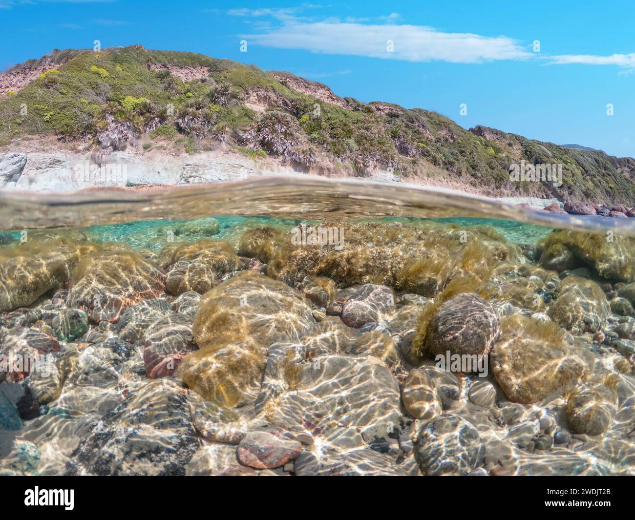 Split underwater view of rocks in La Speranza beach. Sardinia, Italy ...