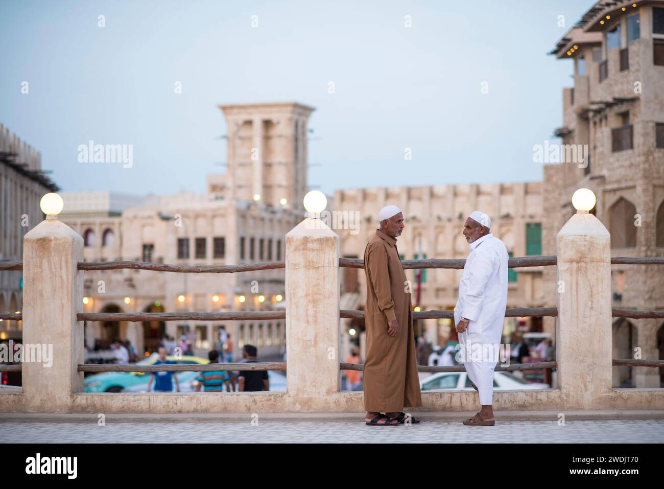 Doha, Qatar - April 22,2023: Local people in traditional attire in old ...