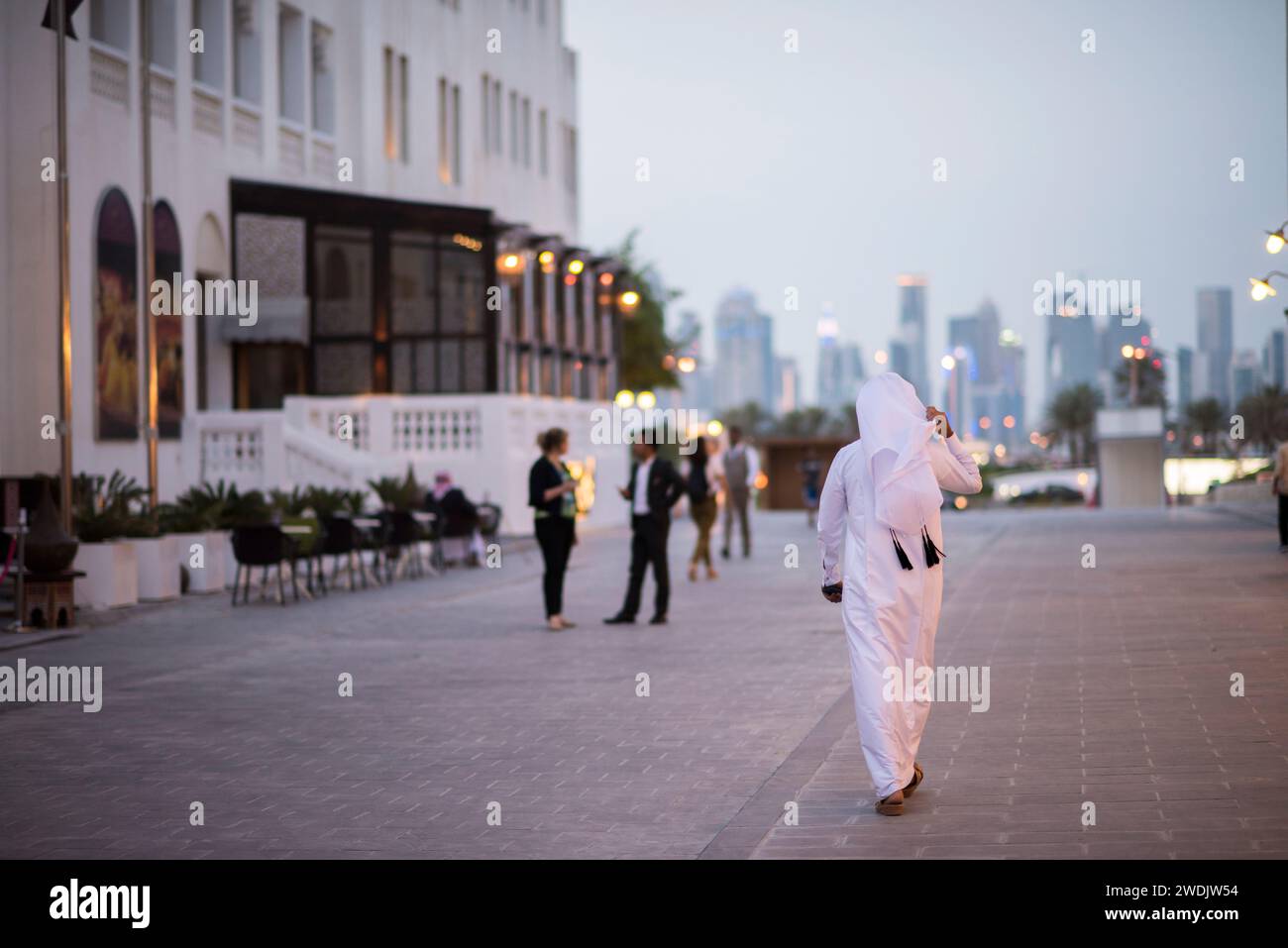 Doha, Qatar - April 22,2023: Local people in traditional attire in old ...