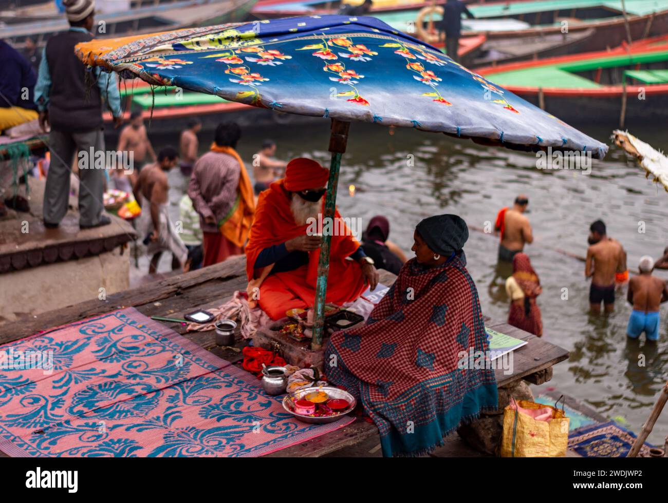 A Hindu Monk sitting on the bank of Ganges river in Varanasi Ghat ...