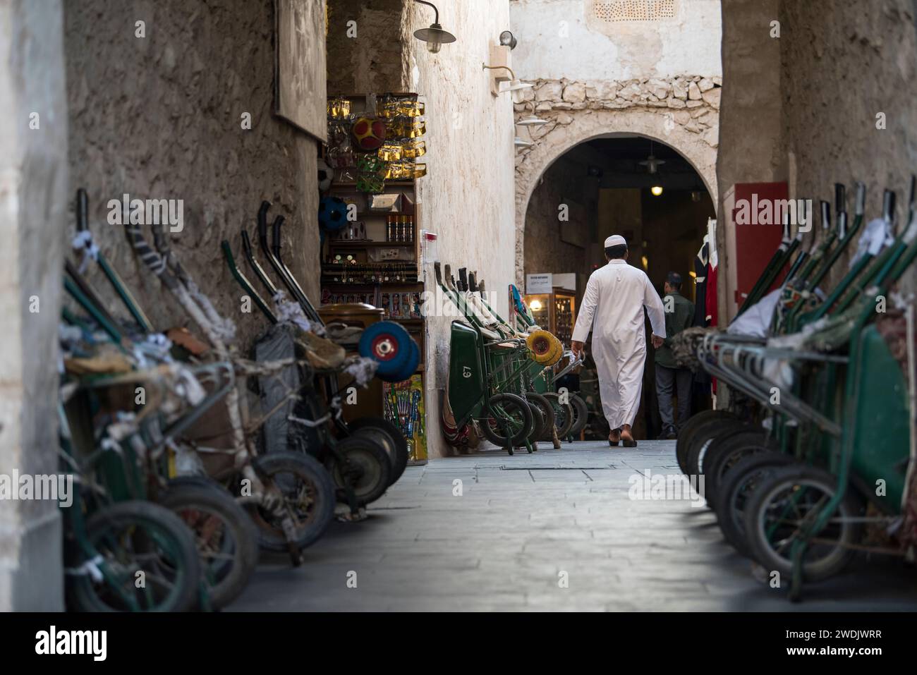Doha, Qatar - April 22,2023: Local people in traditional attire in old ...