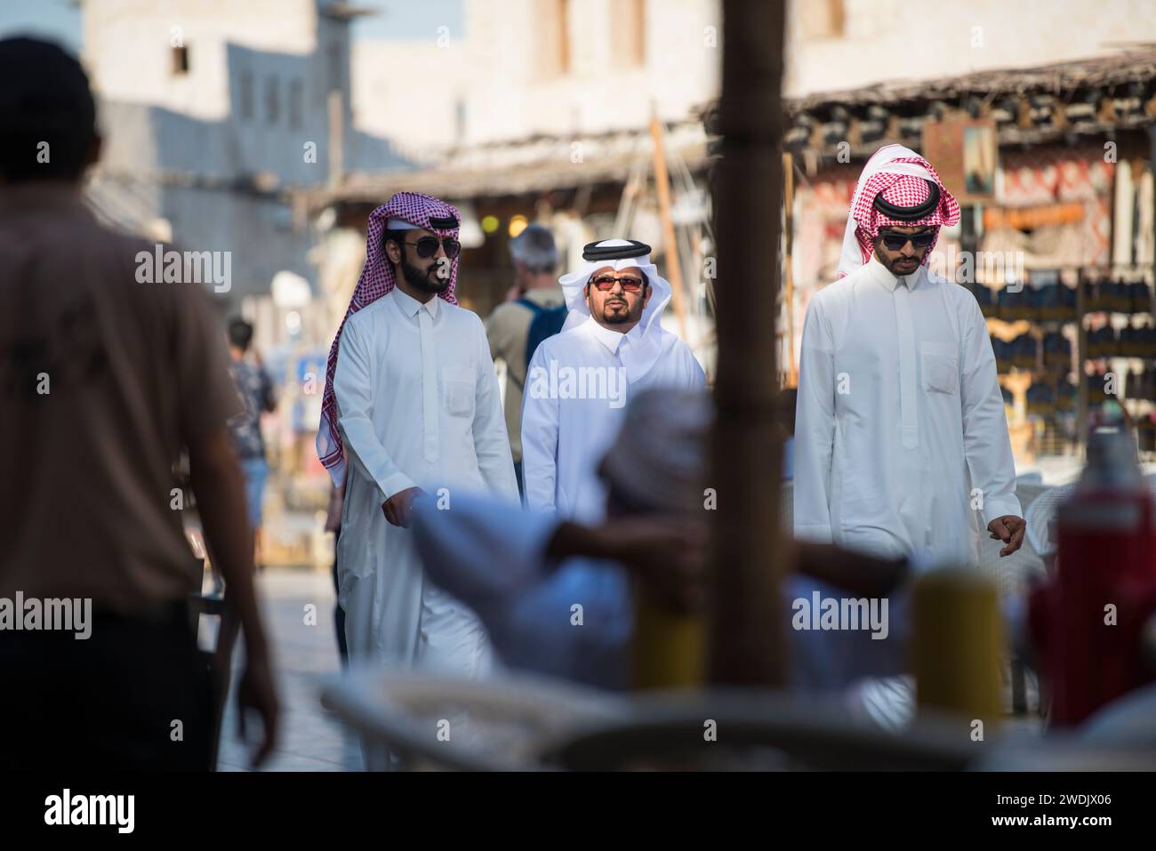 Doha, Qatar - April 22,2023: Local people in traditional attire in old ...