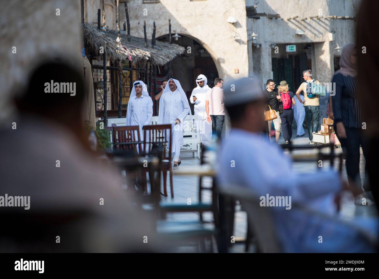 Doha, Qatar - April 22,2023: Local people in traditional attire in old ...