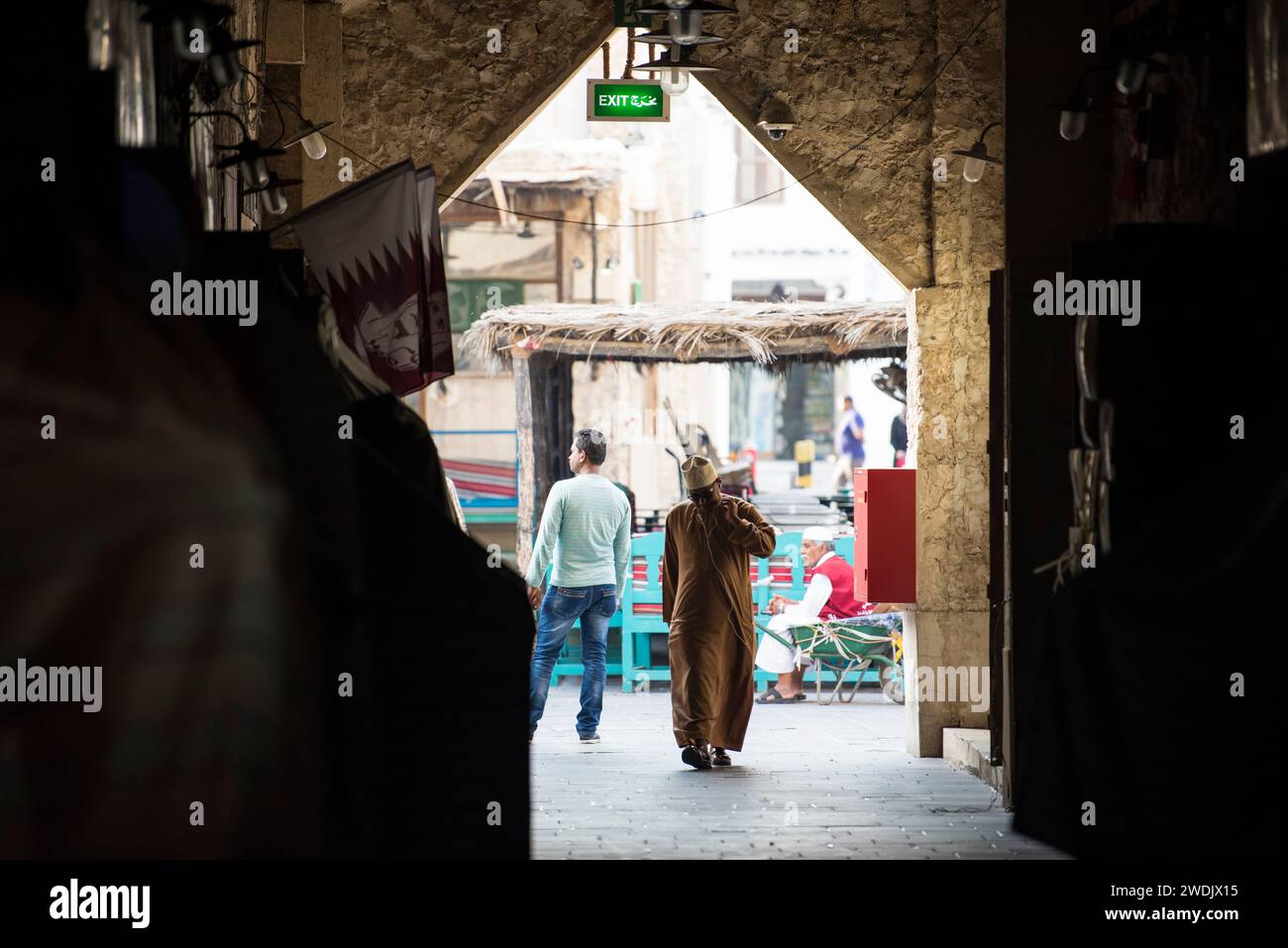Doha, Qatar - April 22,2023: Local people in traditional attire in old ...