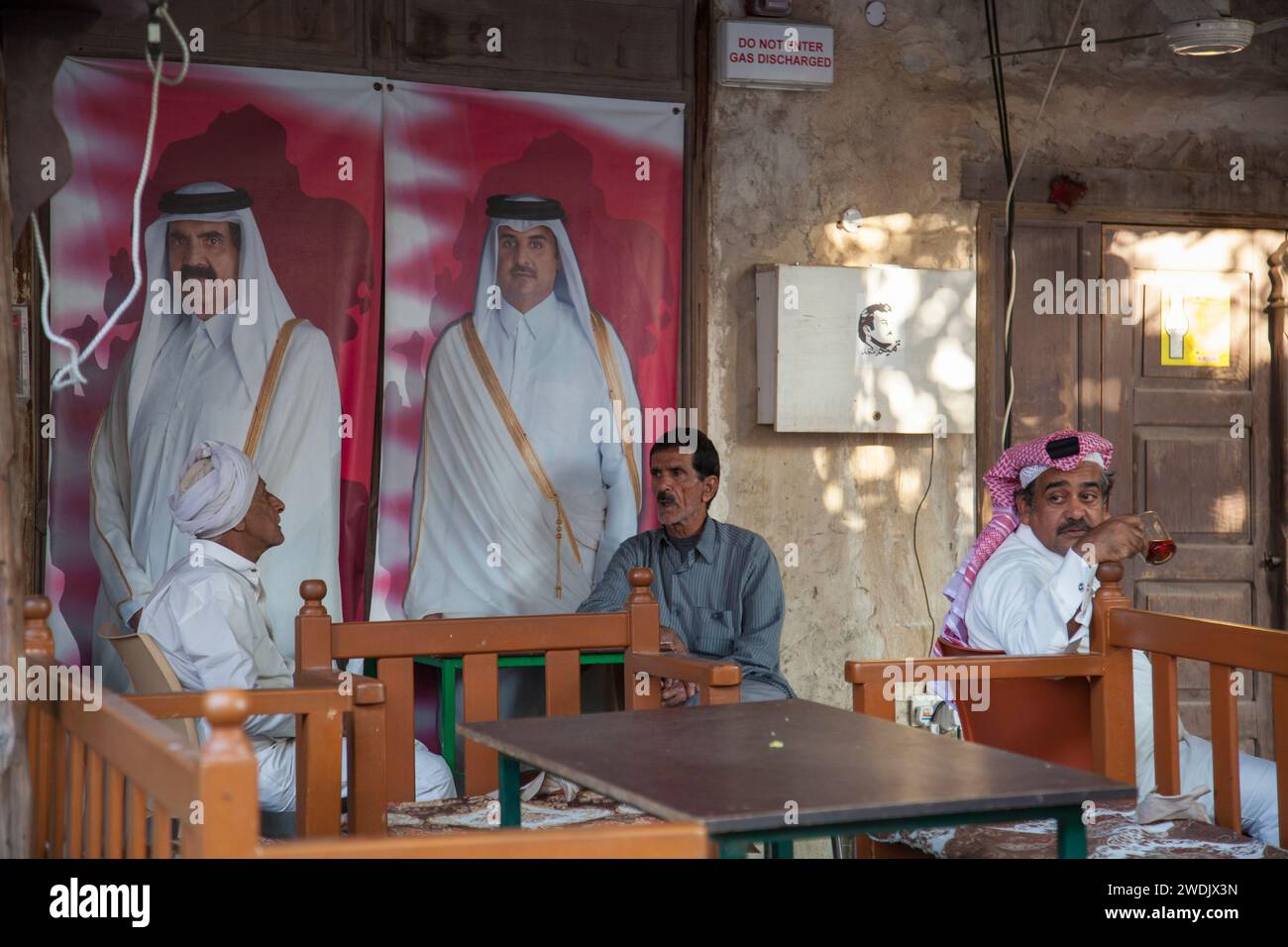 Doha, Qatar - April 22,2023: Local people in traditional attire in old ...