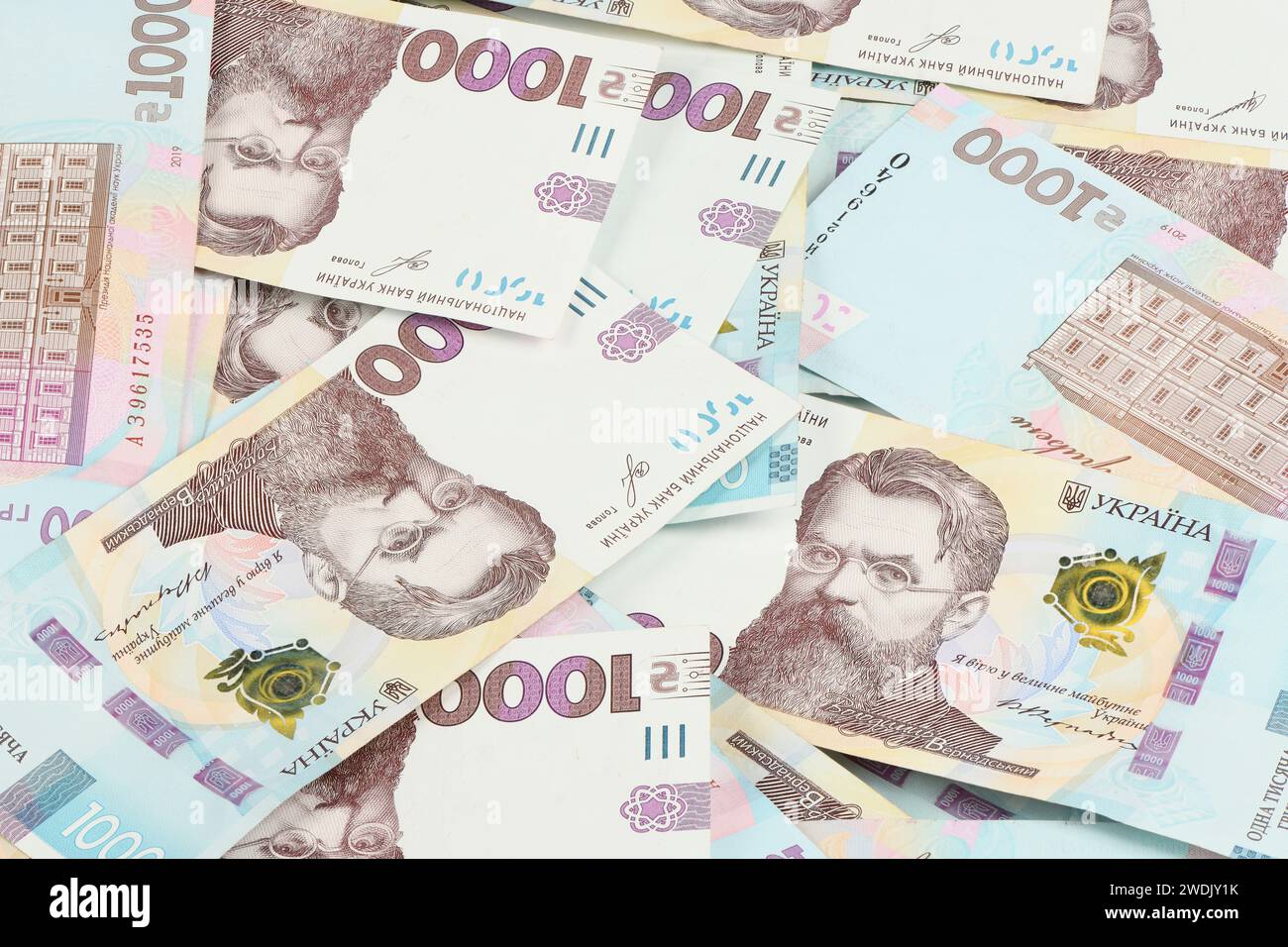 Background of thousand banknotes hryvnia lying in a heap. High ...