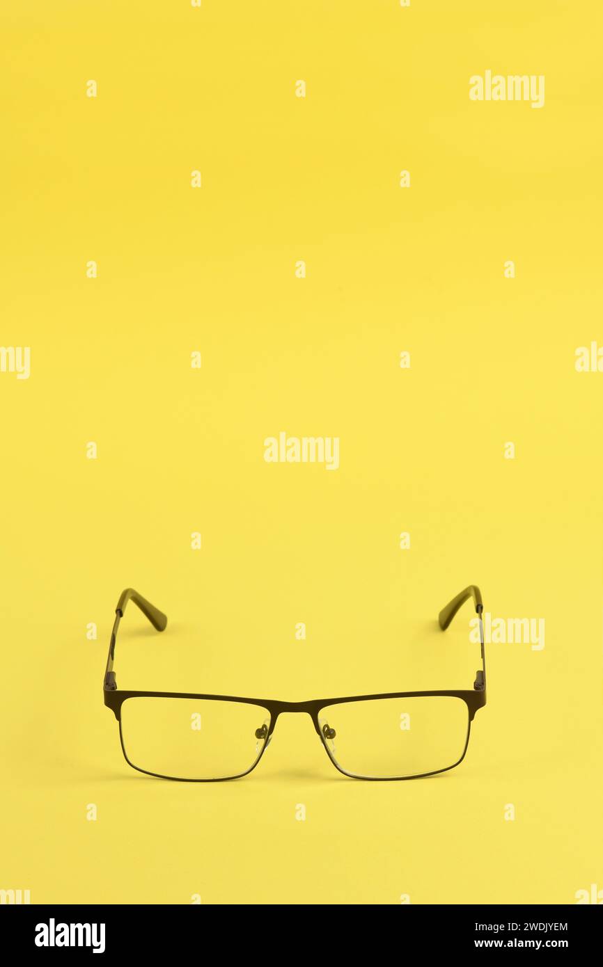 Reading glasses isolated on yellow background. Fashion spectacles for ...