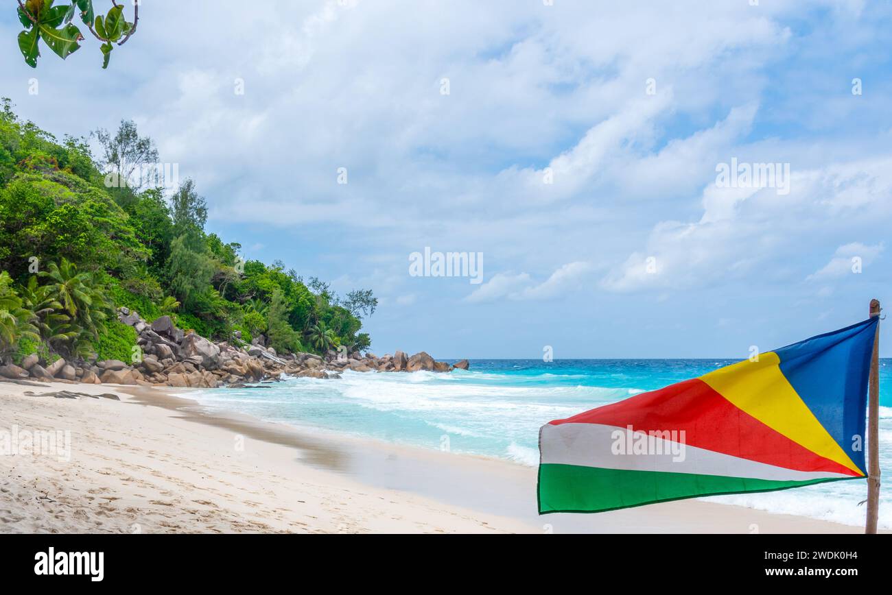 Seychelles flag by the sea in Anse Georgette. Praslin island ...