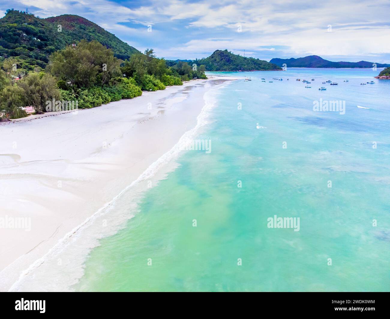 Aerial view of white sand and turquoise water in Anse Volbert beach in ...