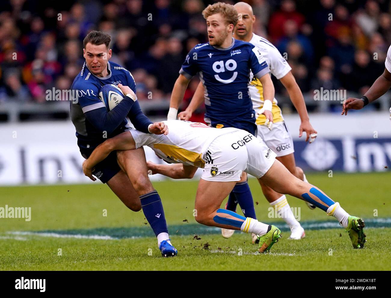 Sale Sharks' Tom Roebuck is tackled by La Rochelle's Tawera Kerr-Barlow ...