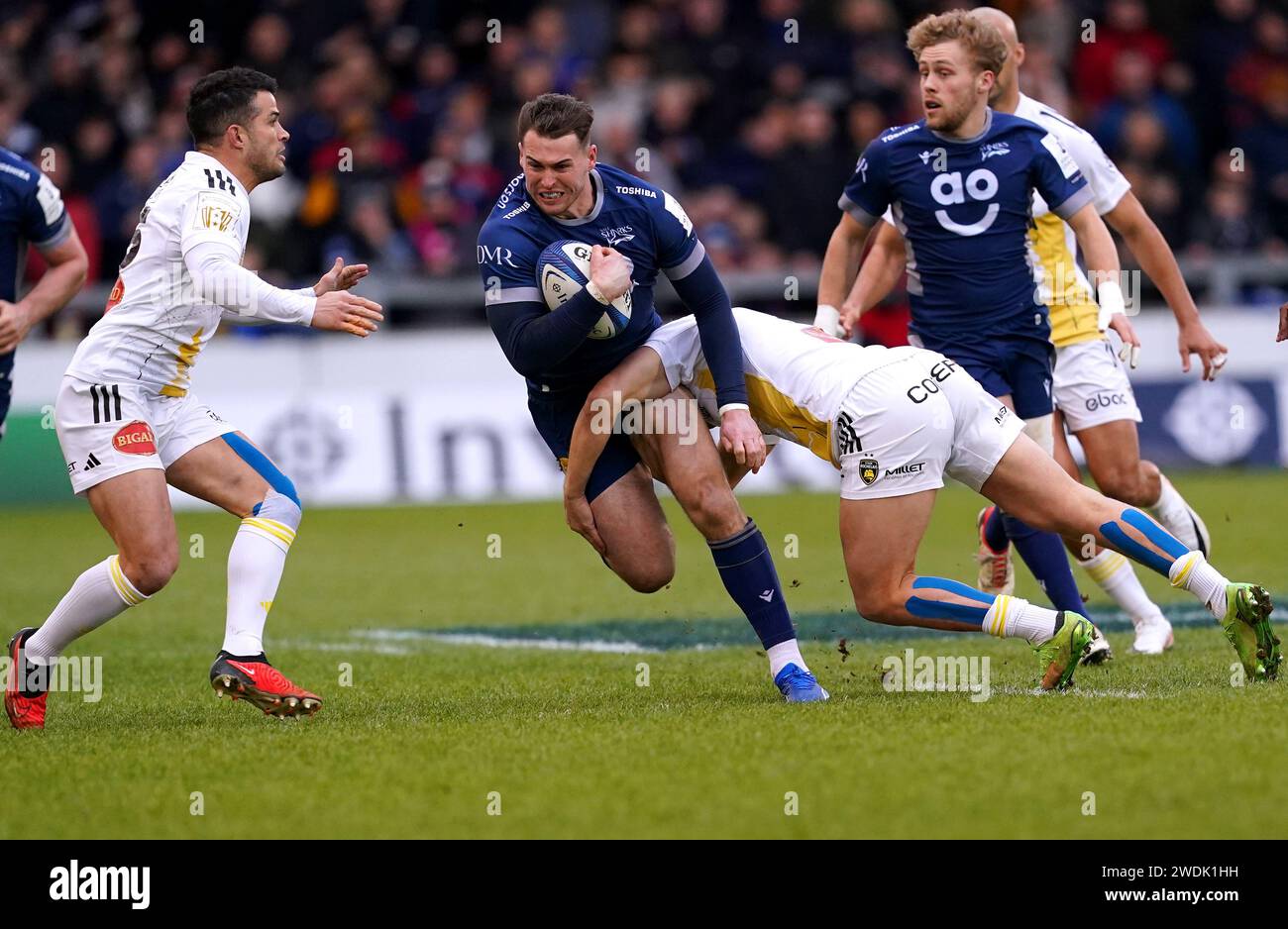 Sale Sharks' Tom Roebuck is tackled by La Rochelle's Tawera Kerr-Barlow ...