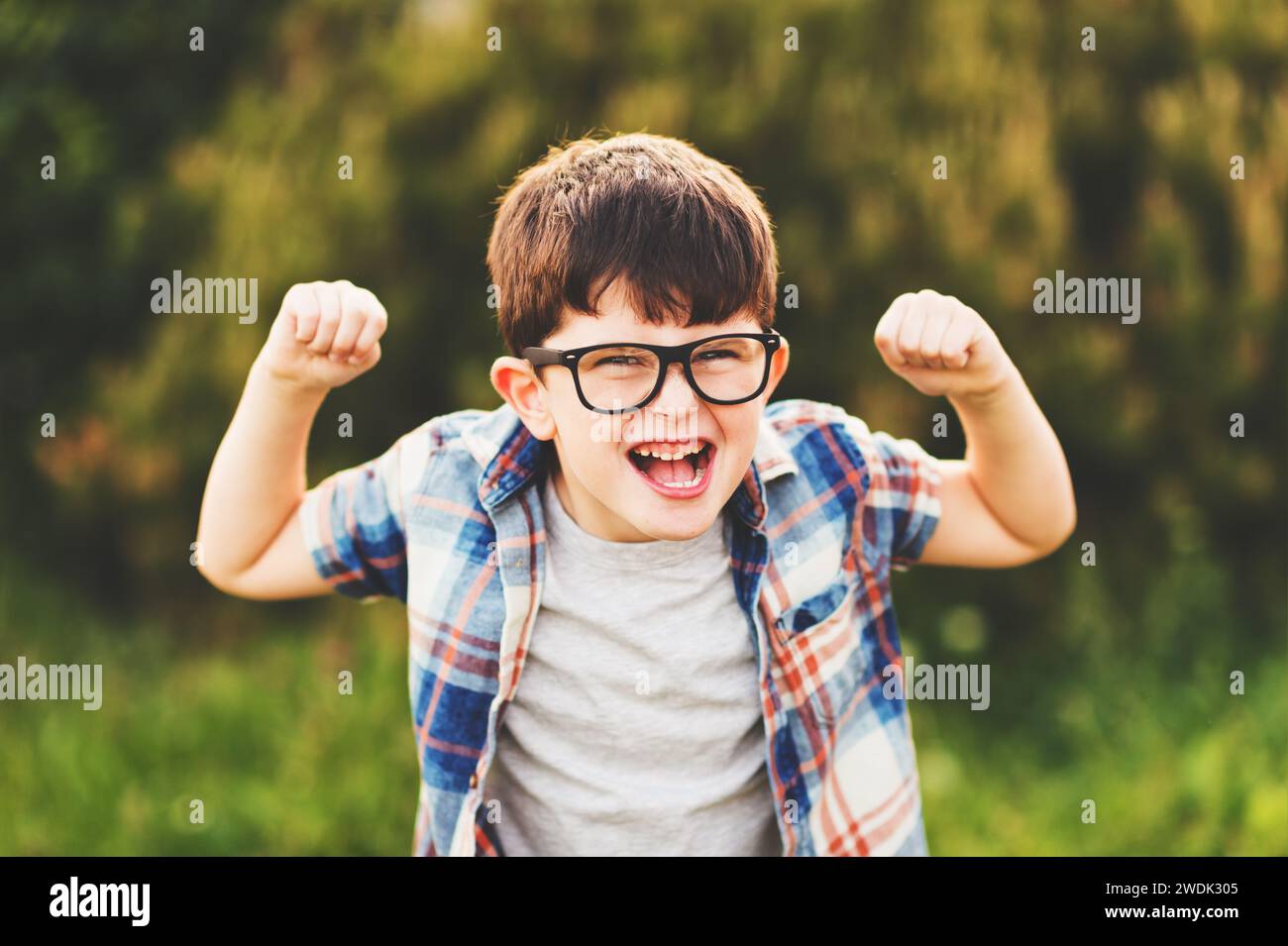 Strong and smart little boy with funny facial expression playing ...