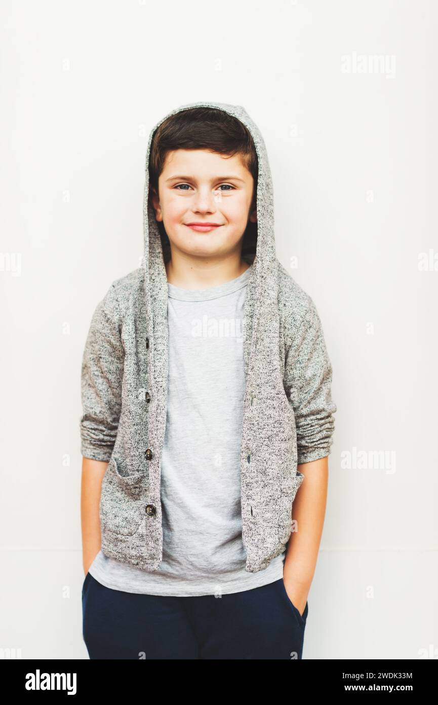 Fashion portrait of adorable kid boy wearing hood jacket Stock Photo ...