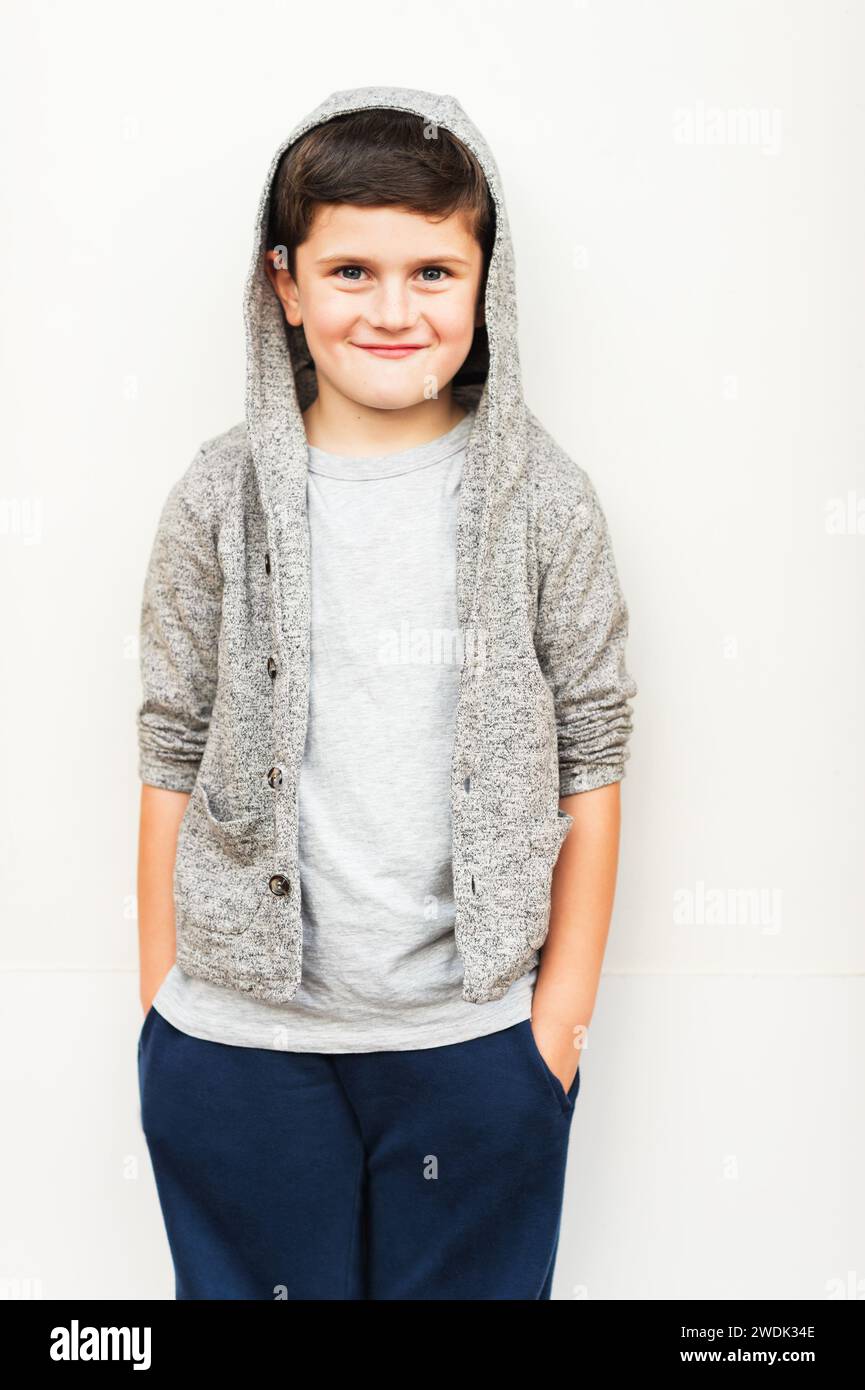 Fashion portrait of adorable kid boy wearing hood jacket Stock Photo ...