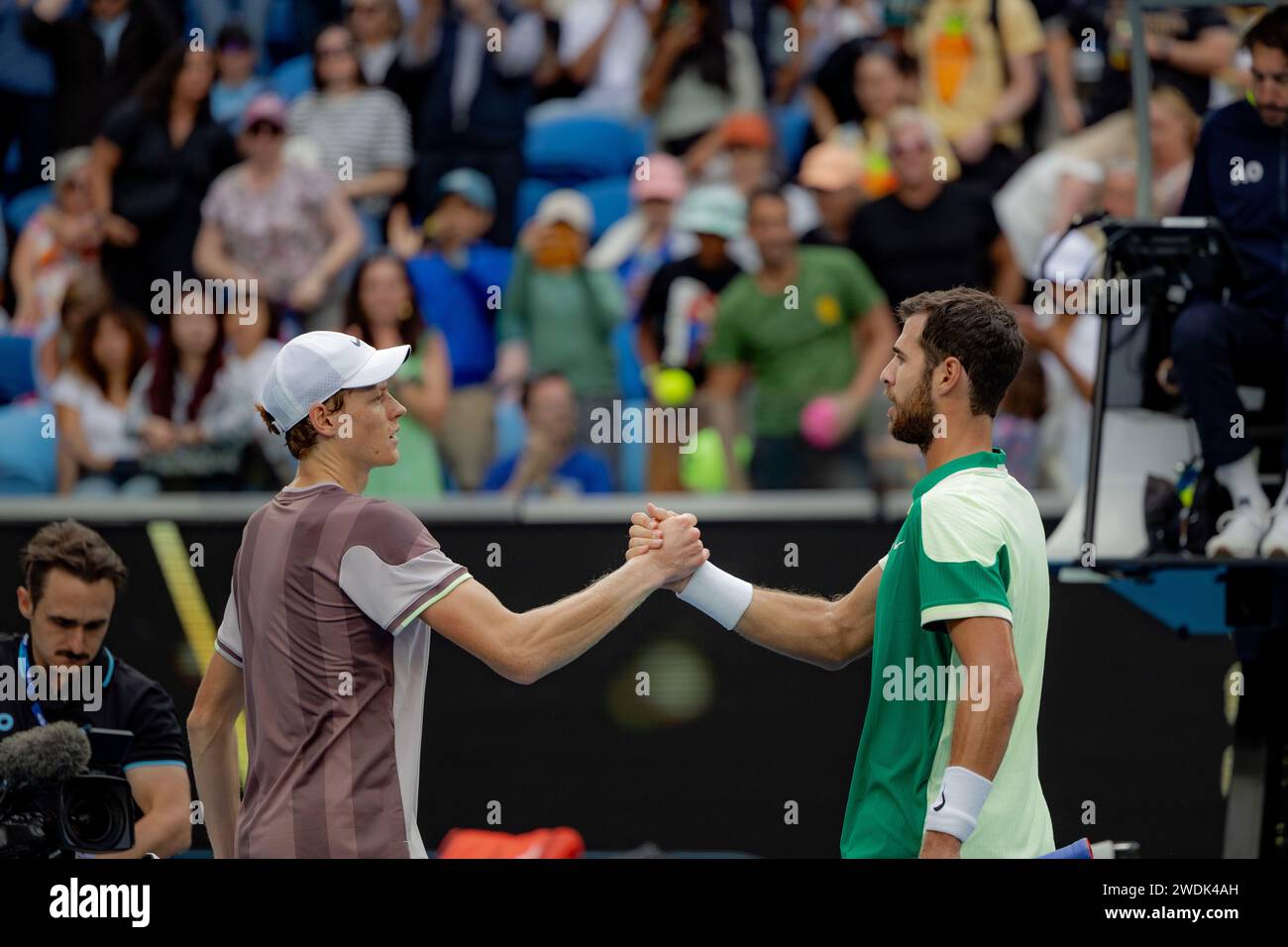 Melbourne, Australia. 21st Jan, 2024. Jannik Sinner (L) of Italy shakes hands with Karen ...