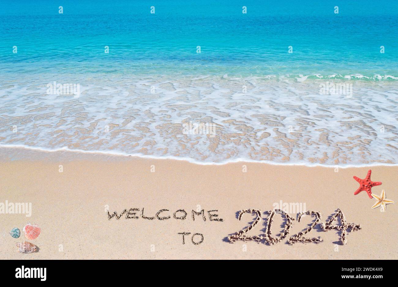 turquoise water and golden sand with shells and sea stars with "welcome ...