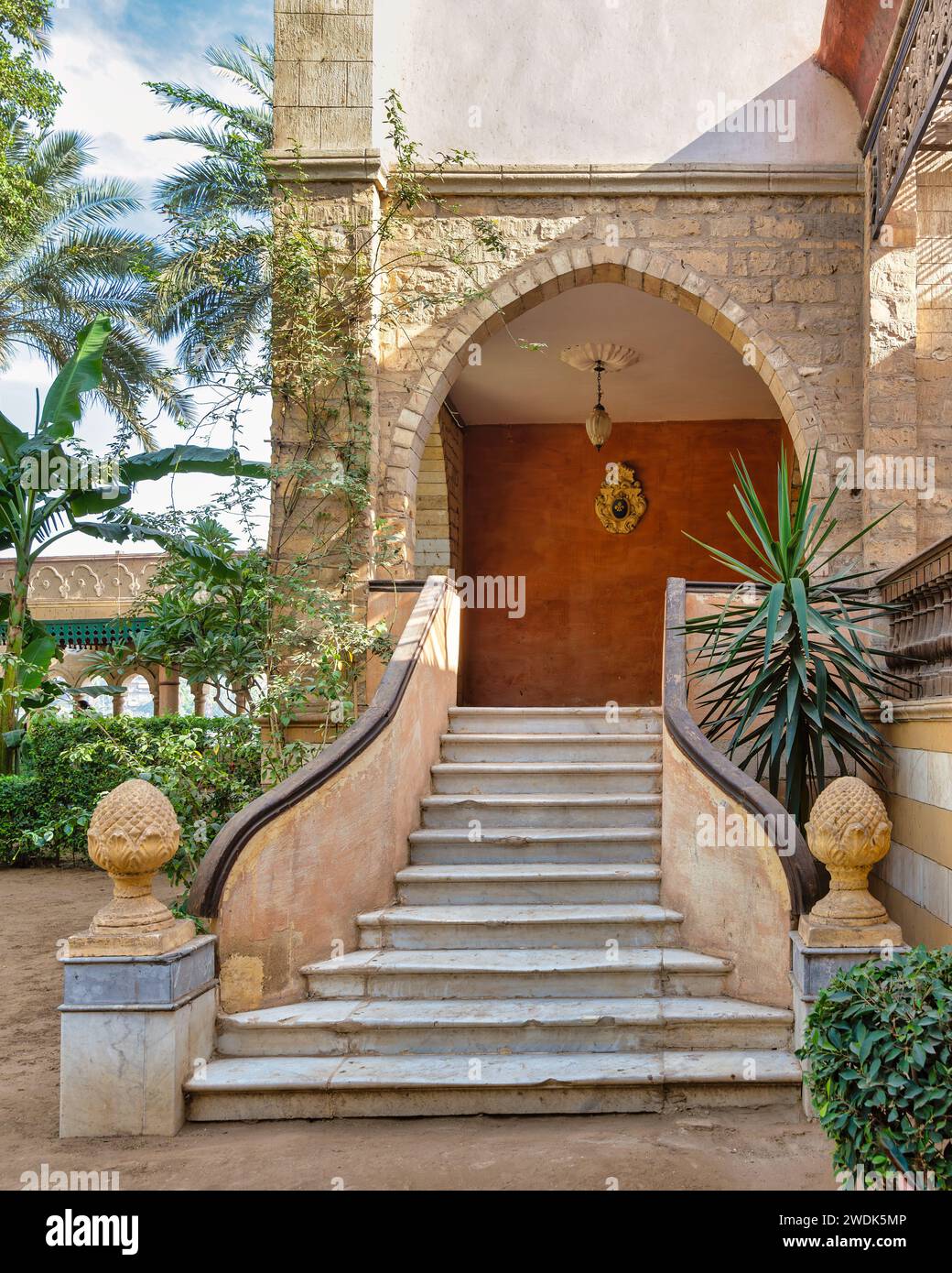 White marble staircase with ornate stone railings, flanked by ...