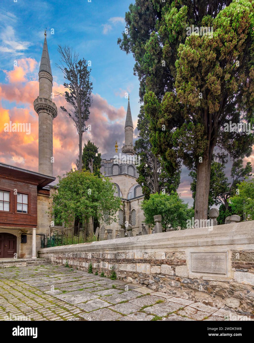 16th century Atik Valide Mosque, surrounded by tall lush trees, located ...