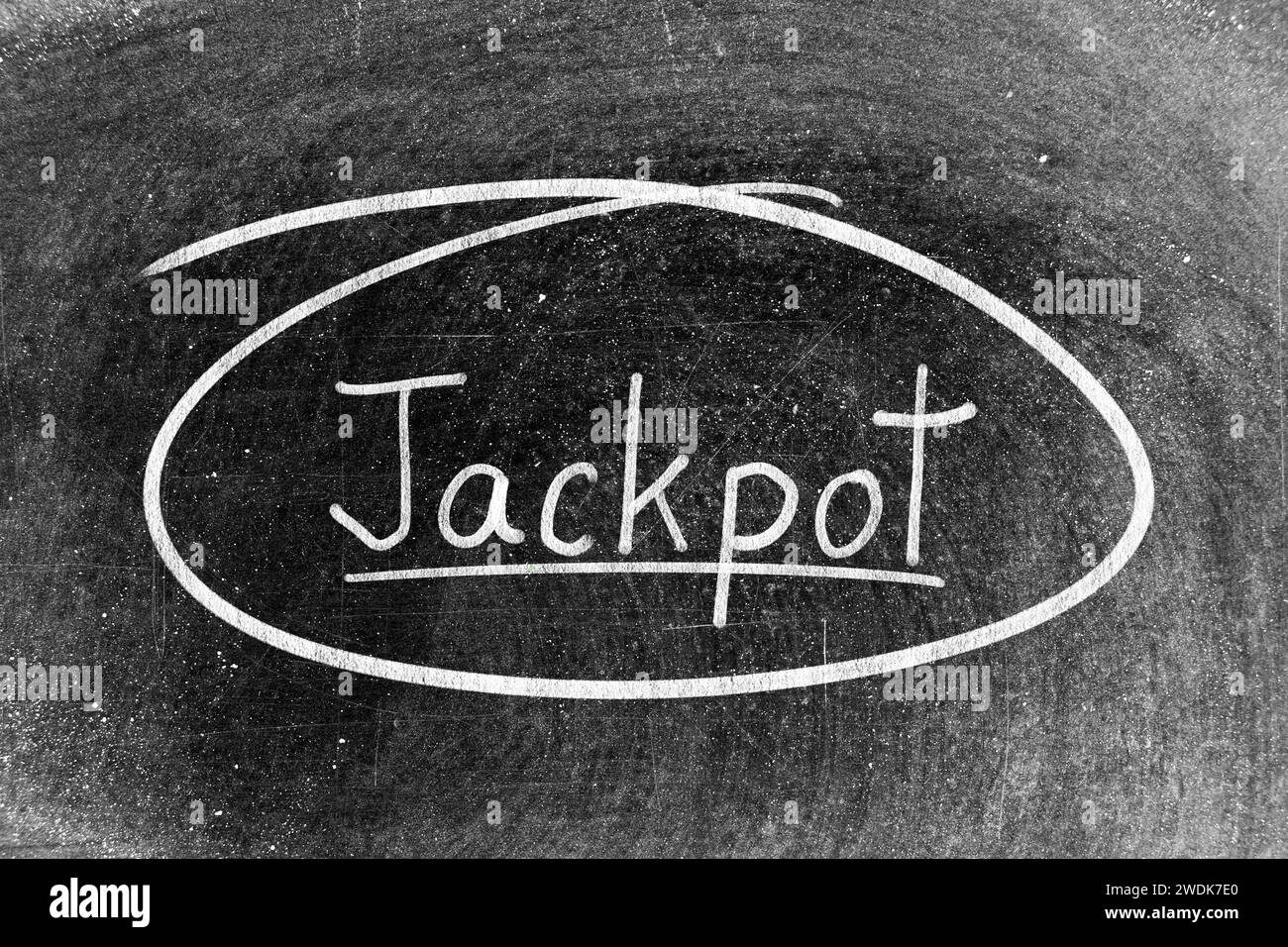 White chalk hand writing in word jackpot and circle shape on blackboard ...