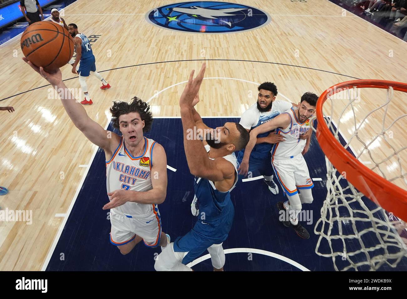 Oklahoma City Thunder guard Josh Giddey, left, goes up for a shot as Minnesota Timberwolves ...