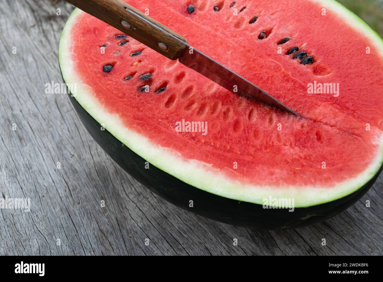 Cutting watermelon in half knife hi-res stock photography and images ...