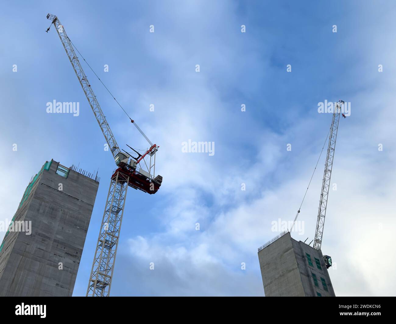 Tower cranes at new high rise apartment development during construction ...