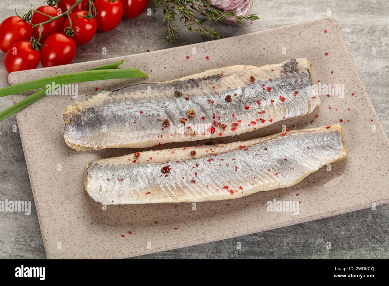 Marinated salted herring fillet with green onion Stock Photo - Alamy