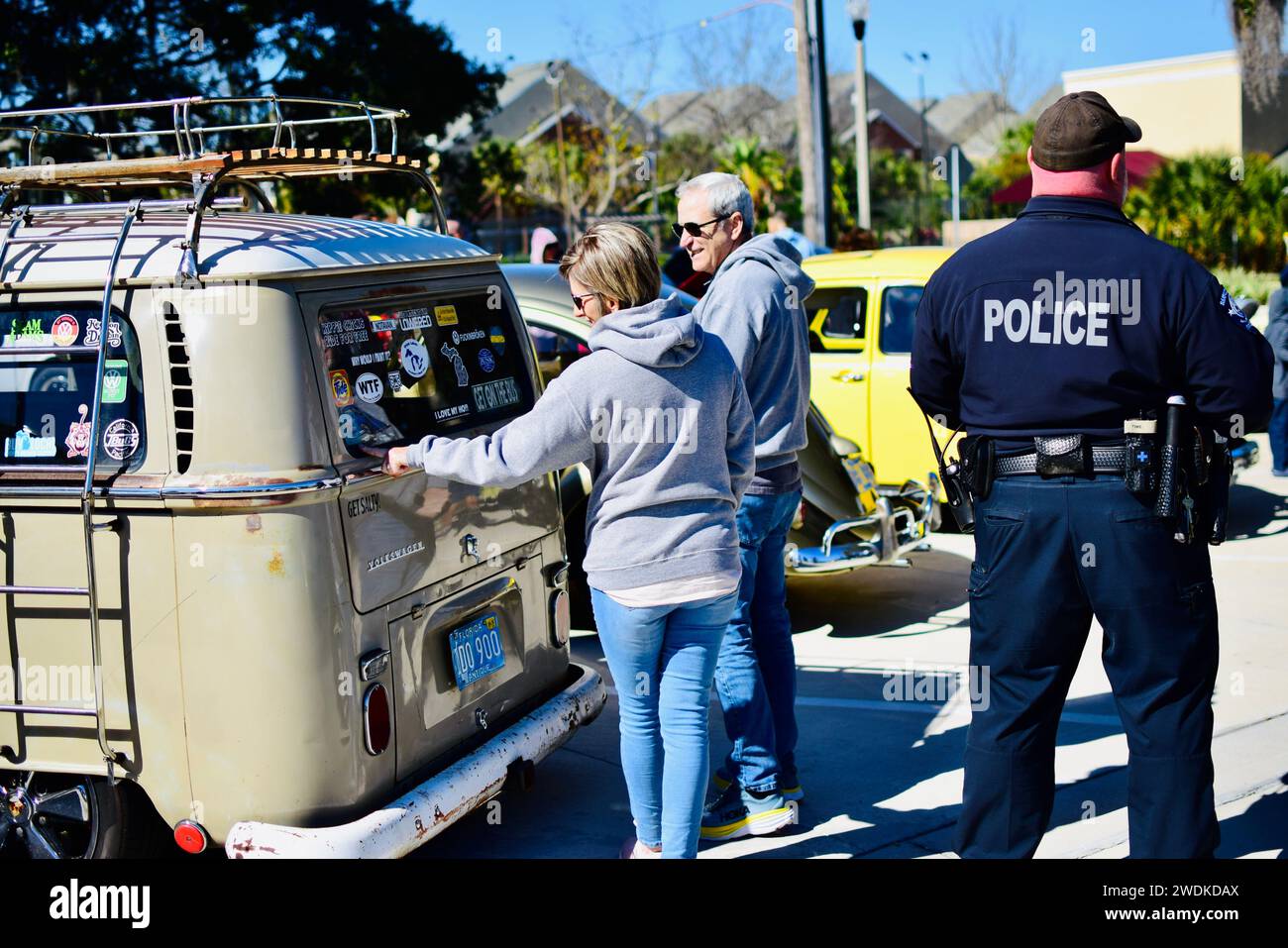 VW car show, couple looking at VW bus, police officer near by Stock ...