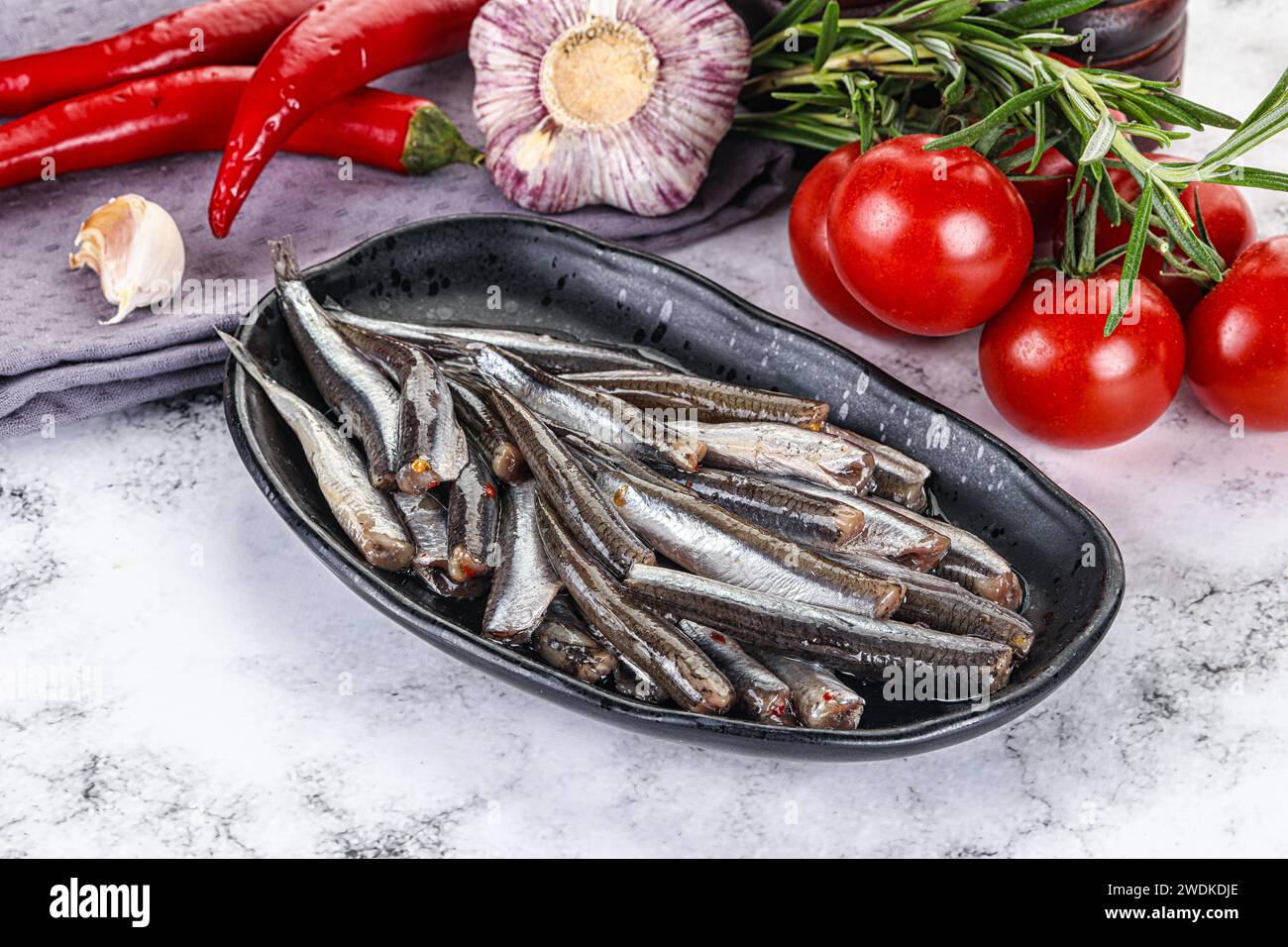 Pickled anchovy fish in the plate Stock Photo - Alamy
