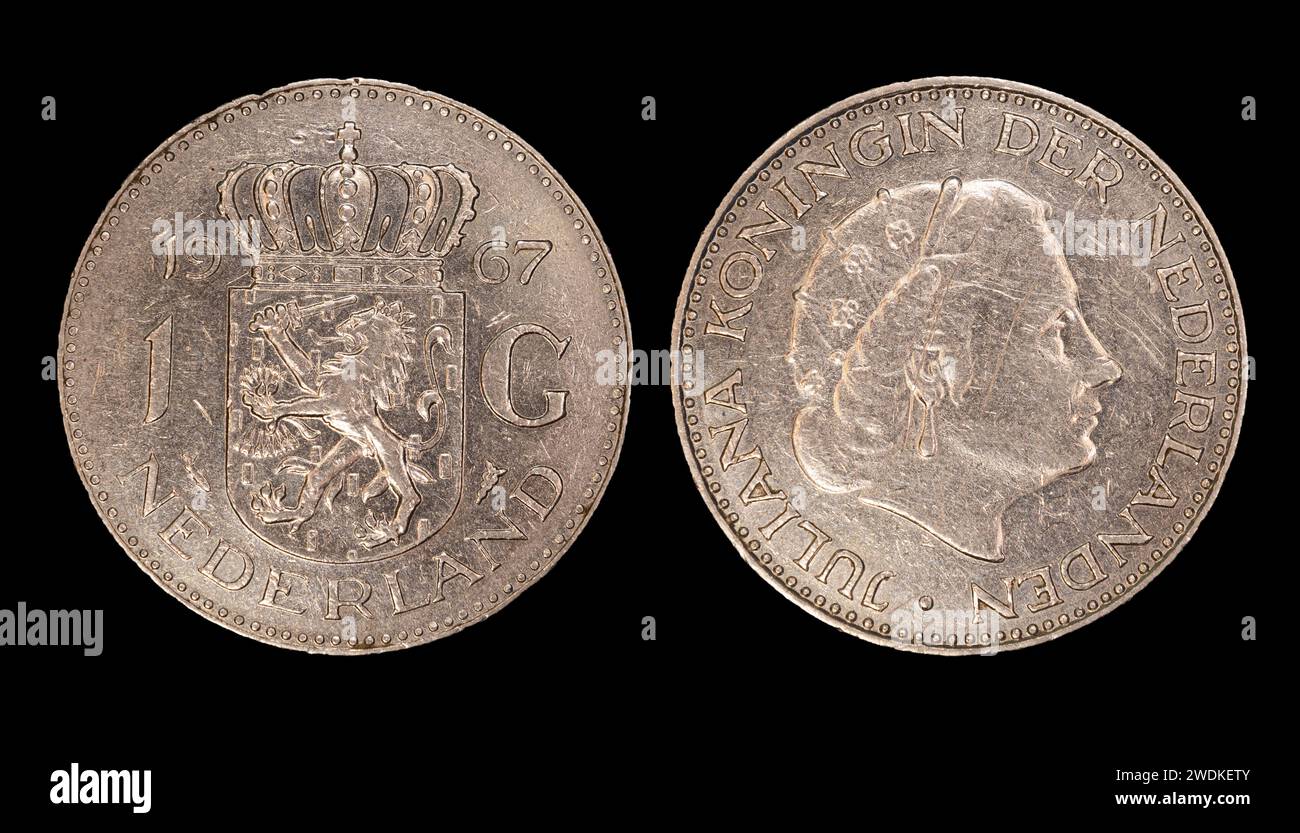 A closeup of Netherlands one gulden coins with queen Juliana on a dark ...