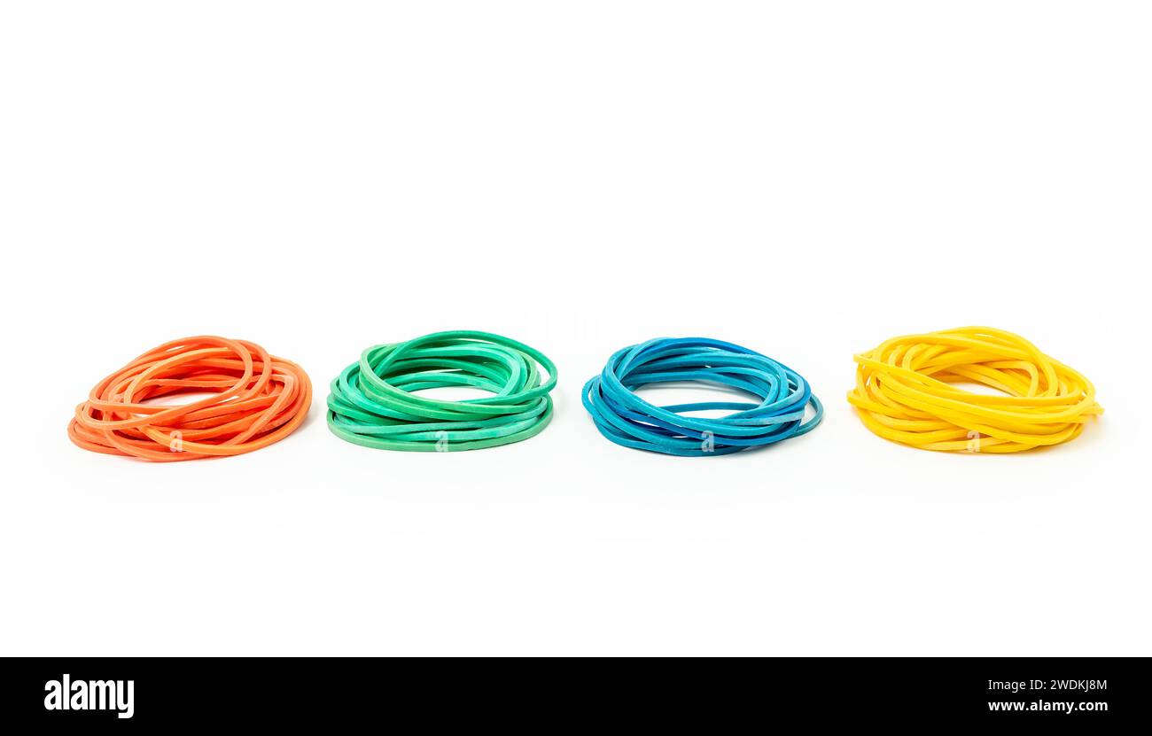 Stacks of different rubber bands on white background. Red, green, blue ...