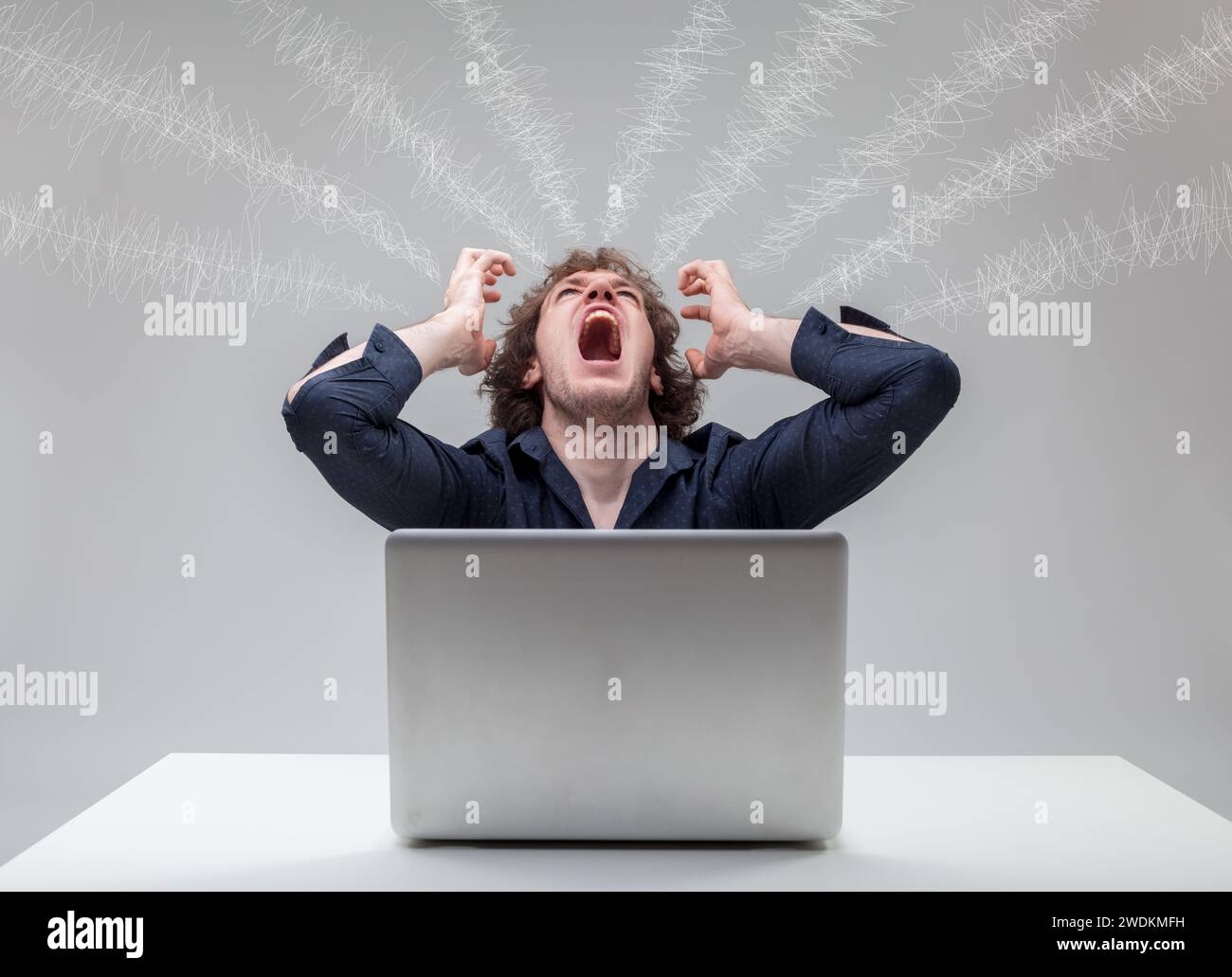 Frustrated male pulls hair in front of computer, shockwaves above ...