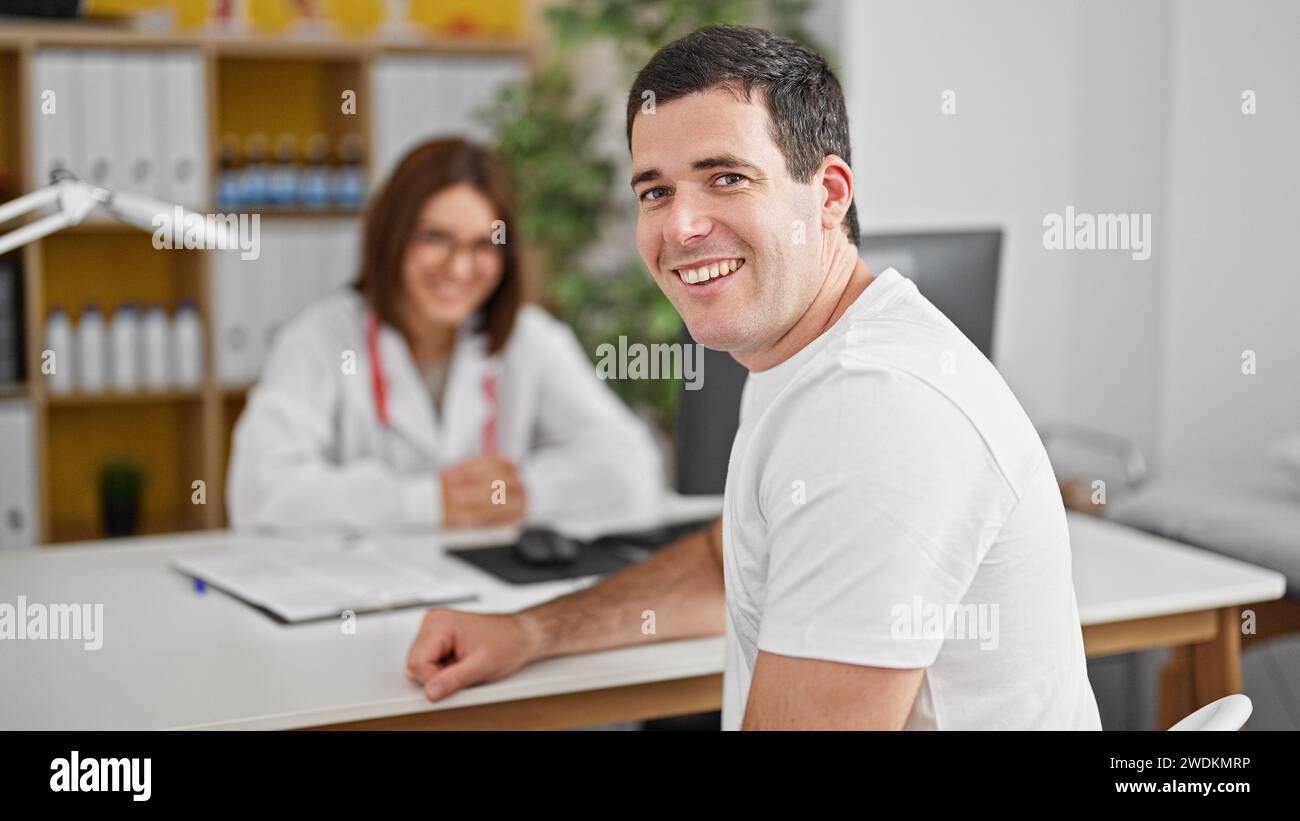 Doctor and patient having medical consultation smiling at the clinic ...