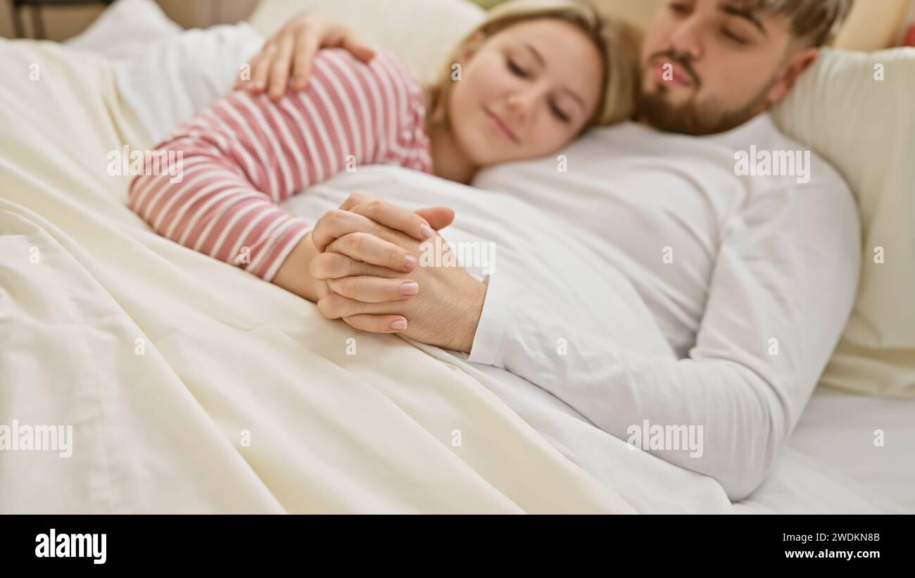 A loving couple embraces in a cozy bedroom, depicting affection and a ...