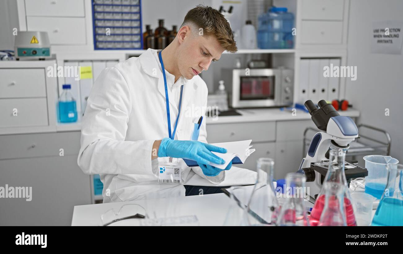 Young caucasian man scientist reading book thinking at laboratory Stock ...