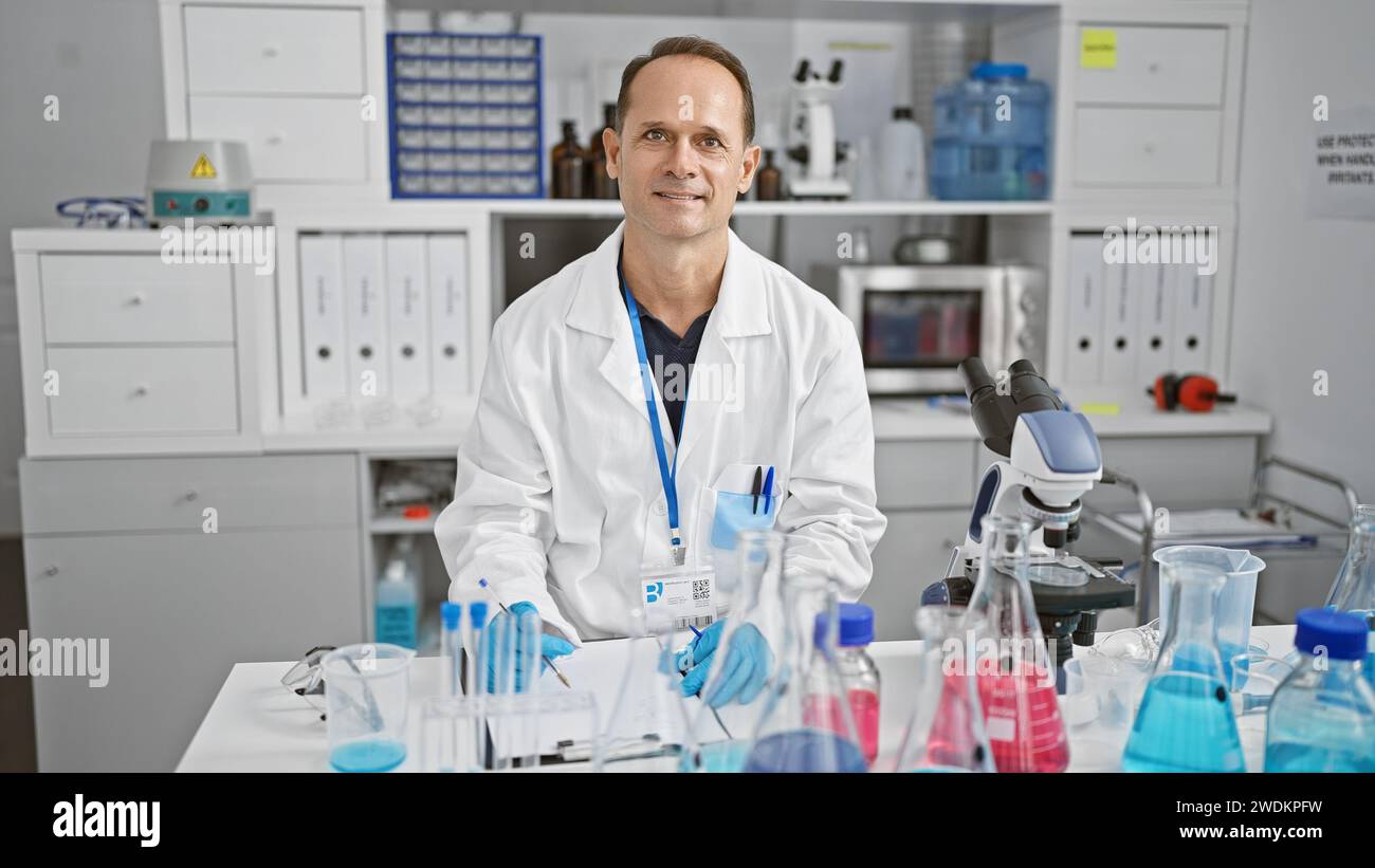 Handsome middle age man scientist, smiling confidently while jotting ...