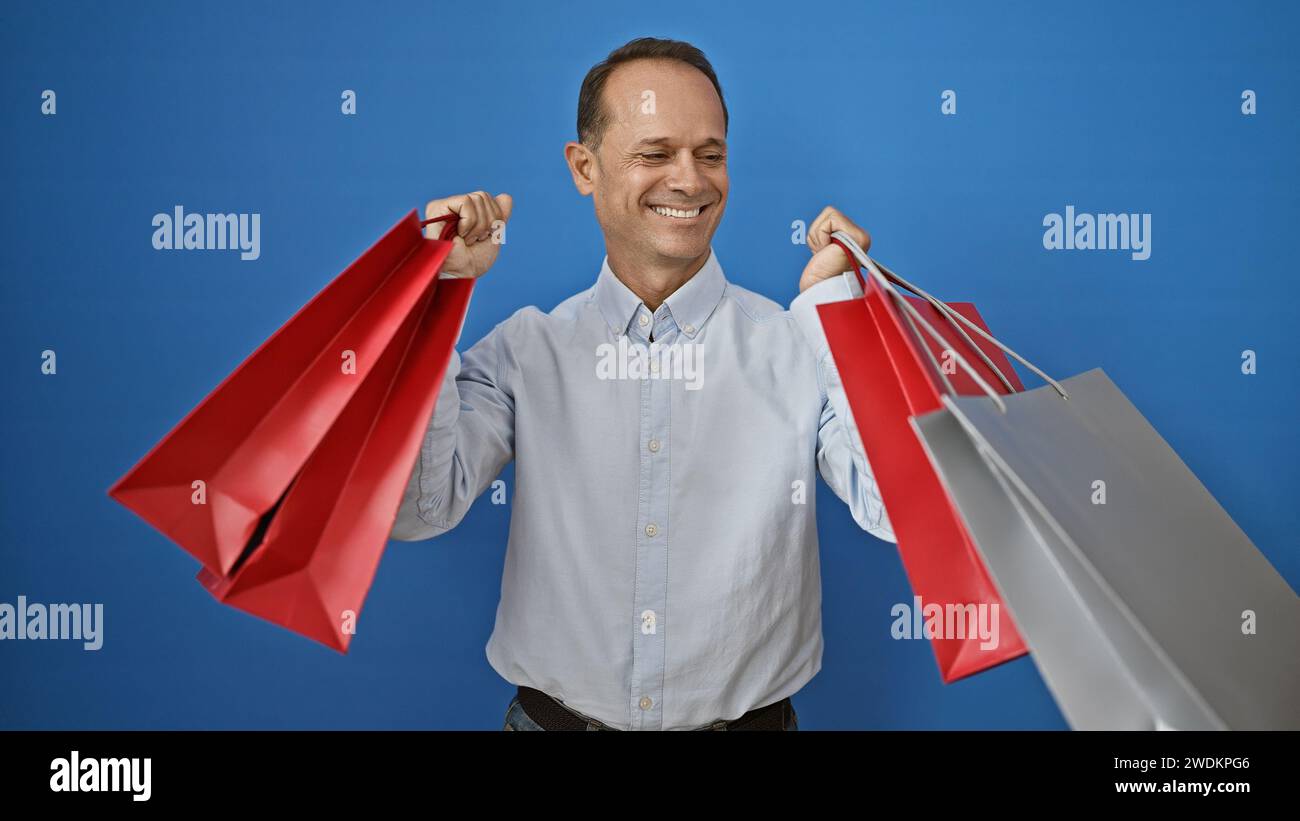 Joyful middle age man, shopper in his happiness, flaunting style with ...