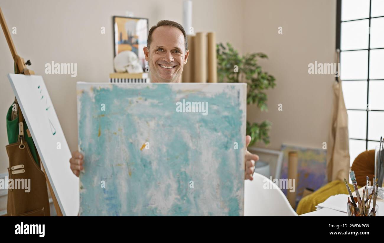 Confident, smiling middle age man artist enjoying his art hobby ...