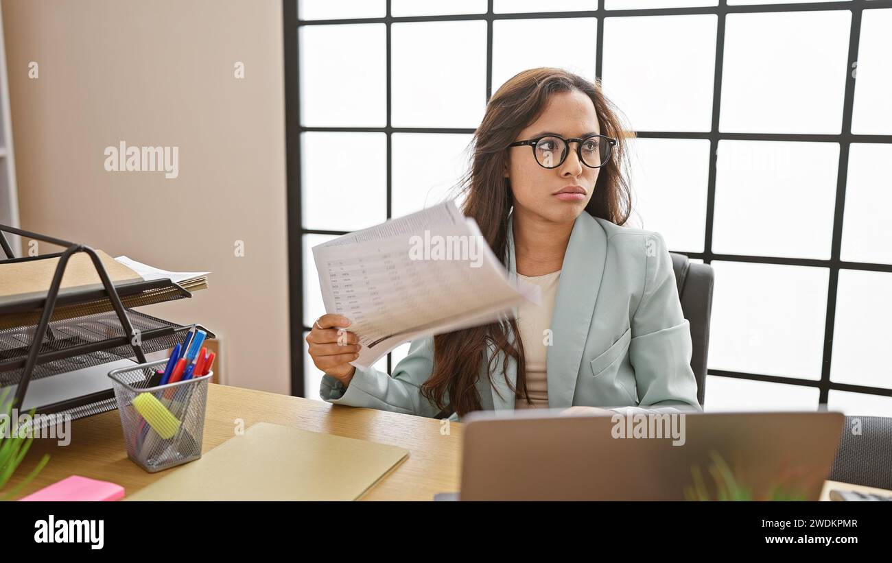 Beautiful, focused young hispanic woman boss making it hot in her air ...