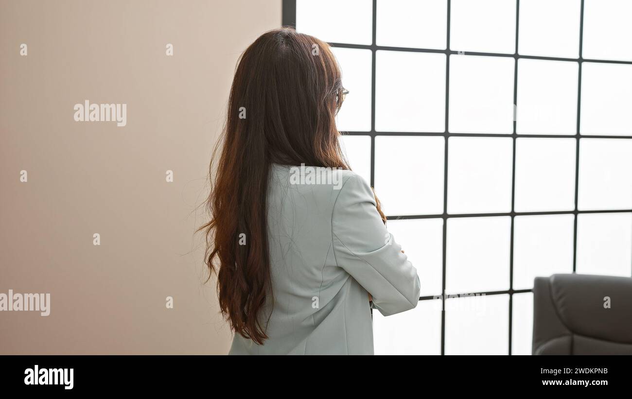 Beautiful young hispanic businesswoman in a bossy pose, armed crossed ...